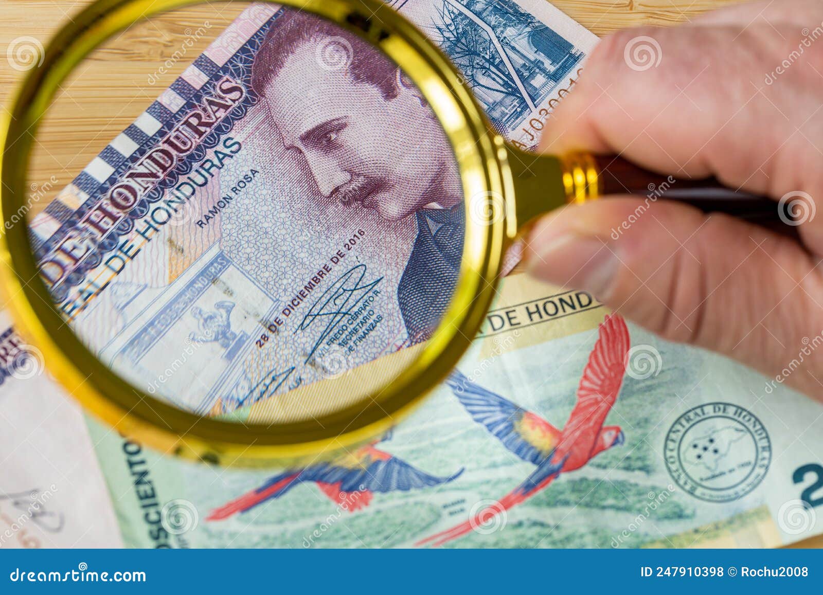 Honduras Money, Banknotes Spread Out on the Table, Lying Magnifier ... Honduras Money, Banknotes Spread Out on the Table, Lying Magnifier ...