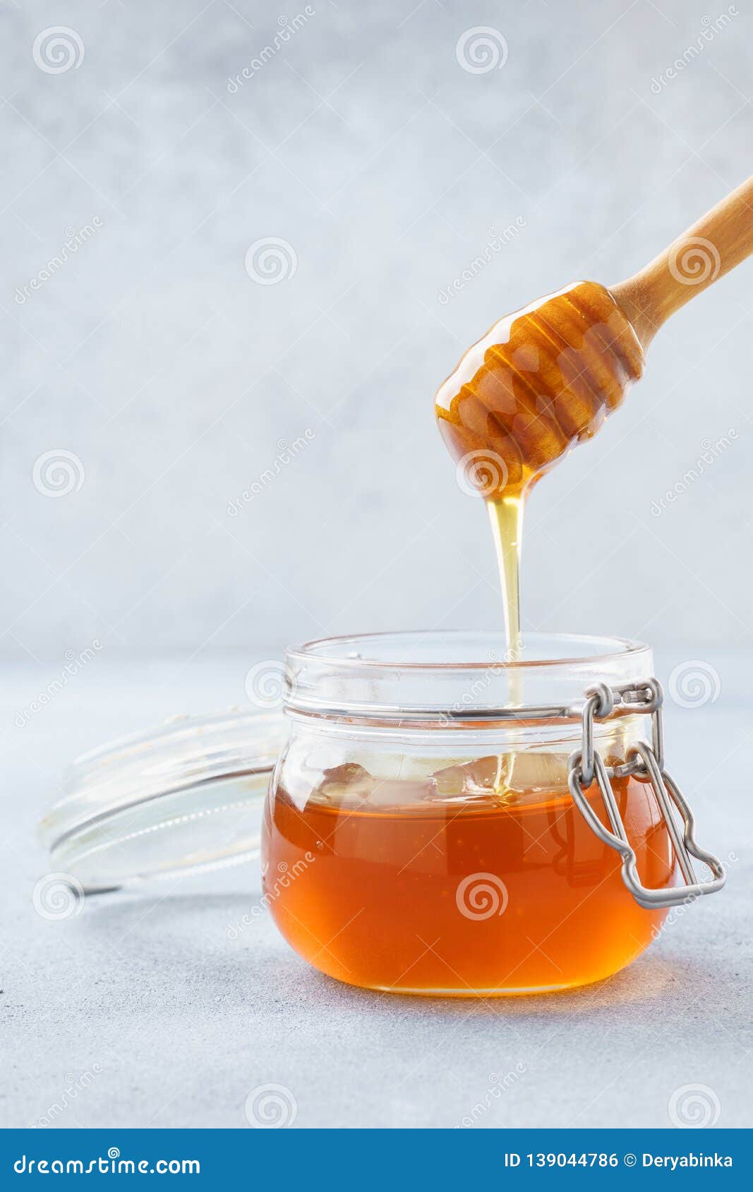 Honey Dripping in a Jar from Wooden Dipper Stock Photo - Image of ...