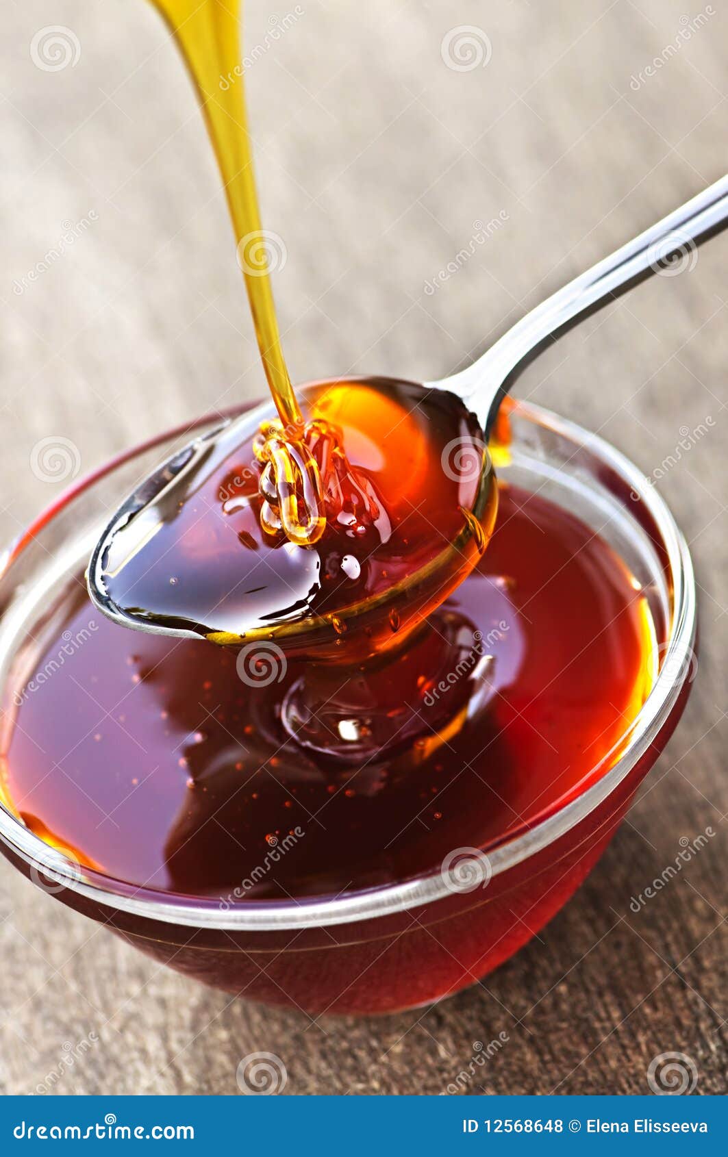 Honey dripping onto spoon stock photo. Image of measure - 12568648