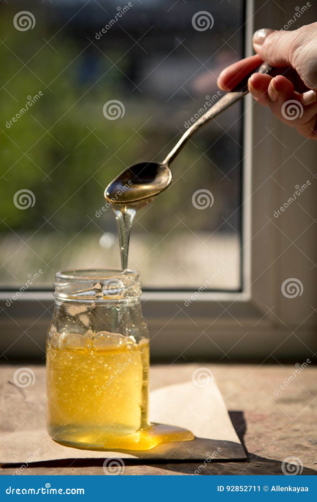 Honey Dripping from a Spoon. Organic Pure Honey in Jar Stock Image ...