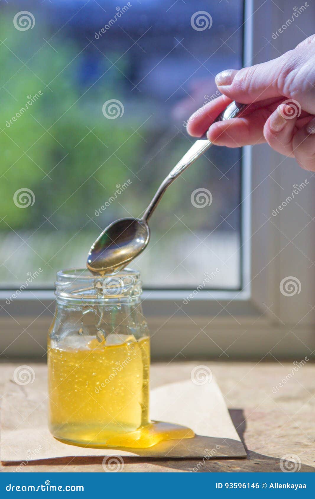 Honey Dripping from a Spoon. Organic Pure Honey in Jar Stock Photo ...