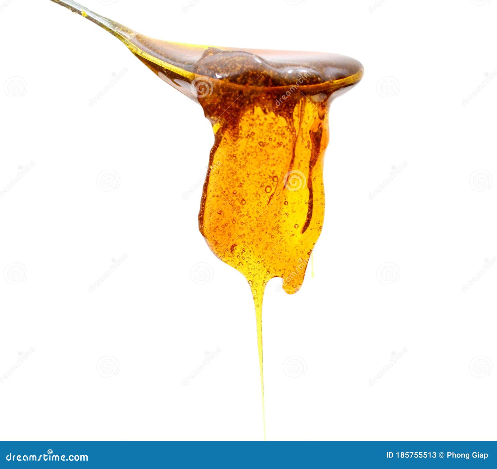 Honey falling on a spoon. stock image. Image of brown - 185755513