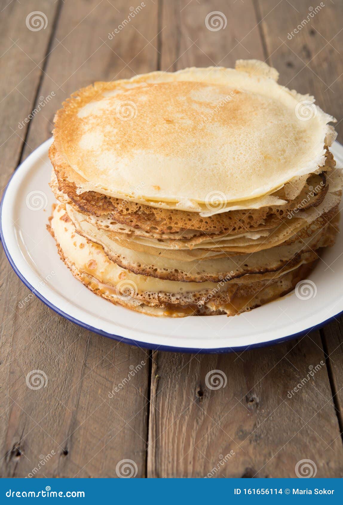Honey or Maple Syrup Pouring Over Crepes. Closeup View of Stack of Thin ...
