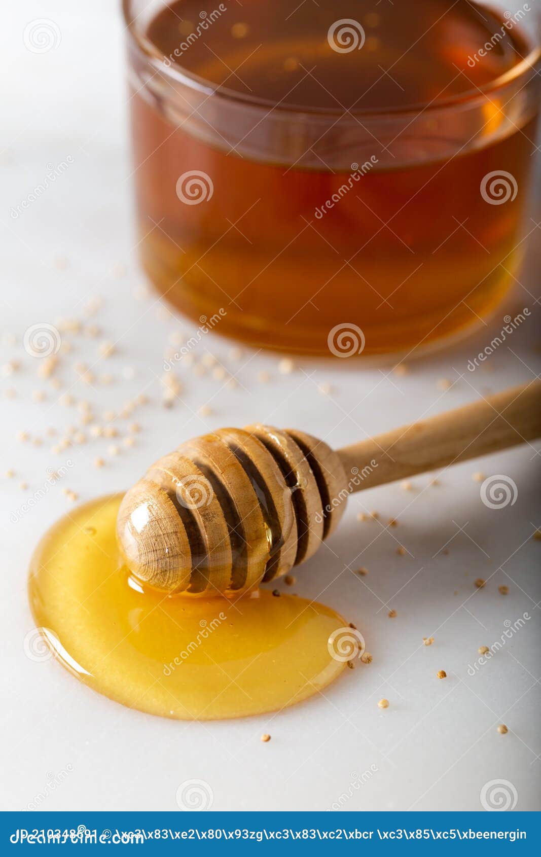 Honey Stick with Flowing Honey and Bee Pollen Granules on the Marble ...