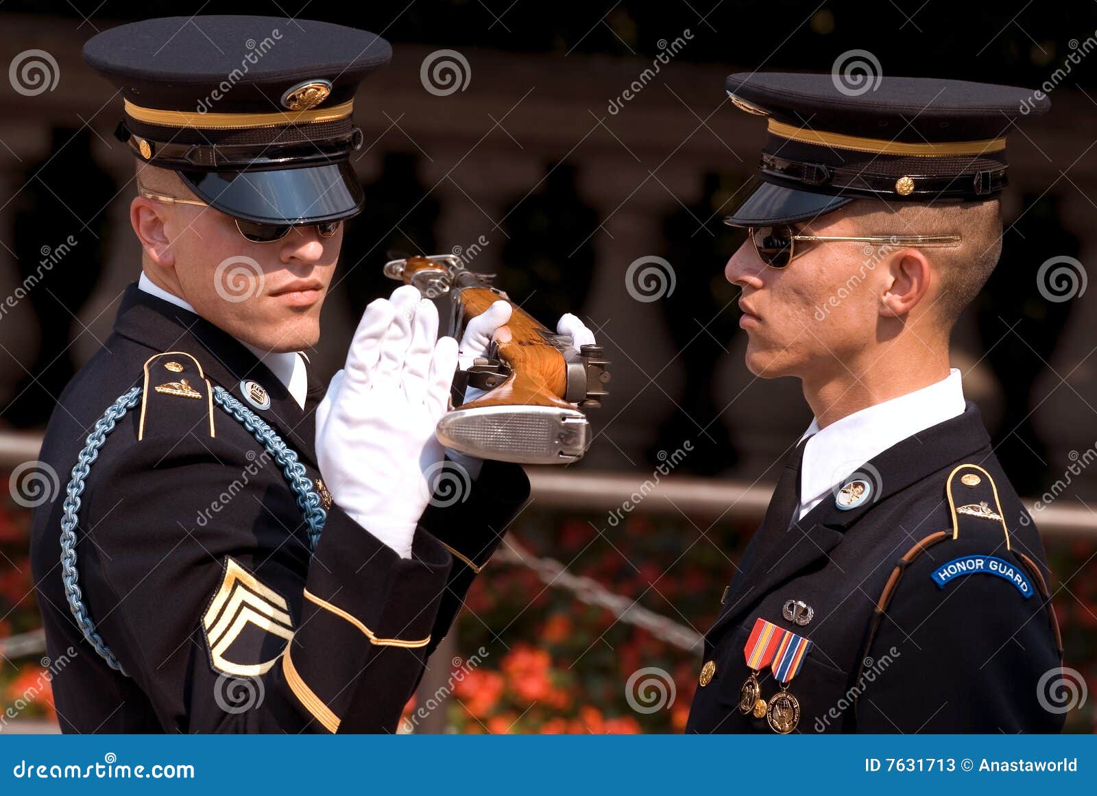 An Honor Guard In Full Ceremonial Uniform Stands Beside A Bronze Statue ...