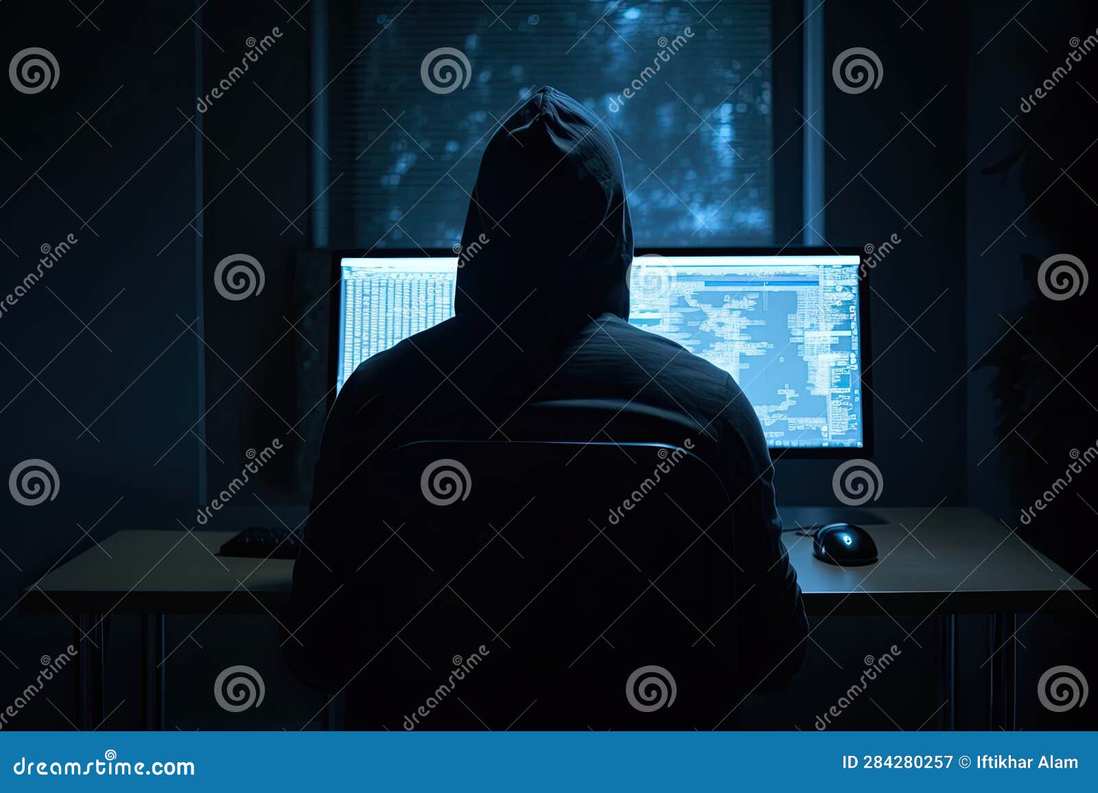 Hooded Hacker Sitting in Front of Computer Monitor in a Dark Room, an ...