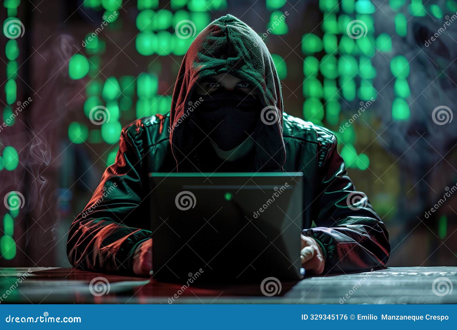 A Hooded Man is Sitting at a Table with a Laptop. he is a Hacker Stock ...