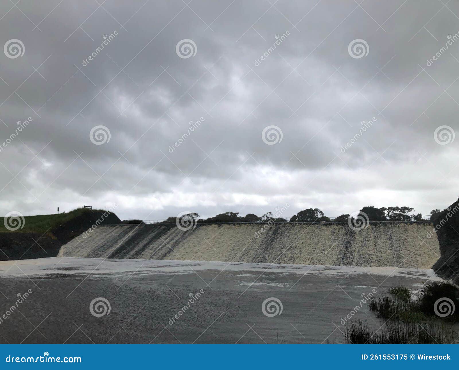 Horizontal Image of a Wide Flowing River with a Small Waterfall on it ...