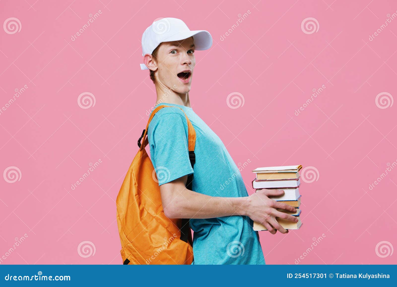Horizontal Photo of a Student in Bright Clothes with Textbooks in His ...