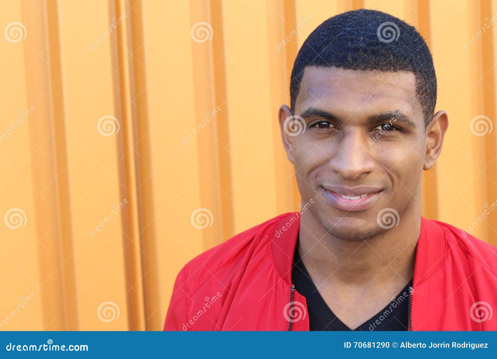 Horizontal Portrait of a Handsome Young African Man Smiling on Orange ...