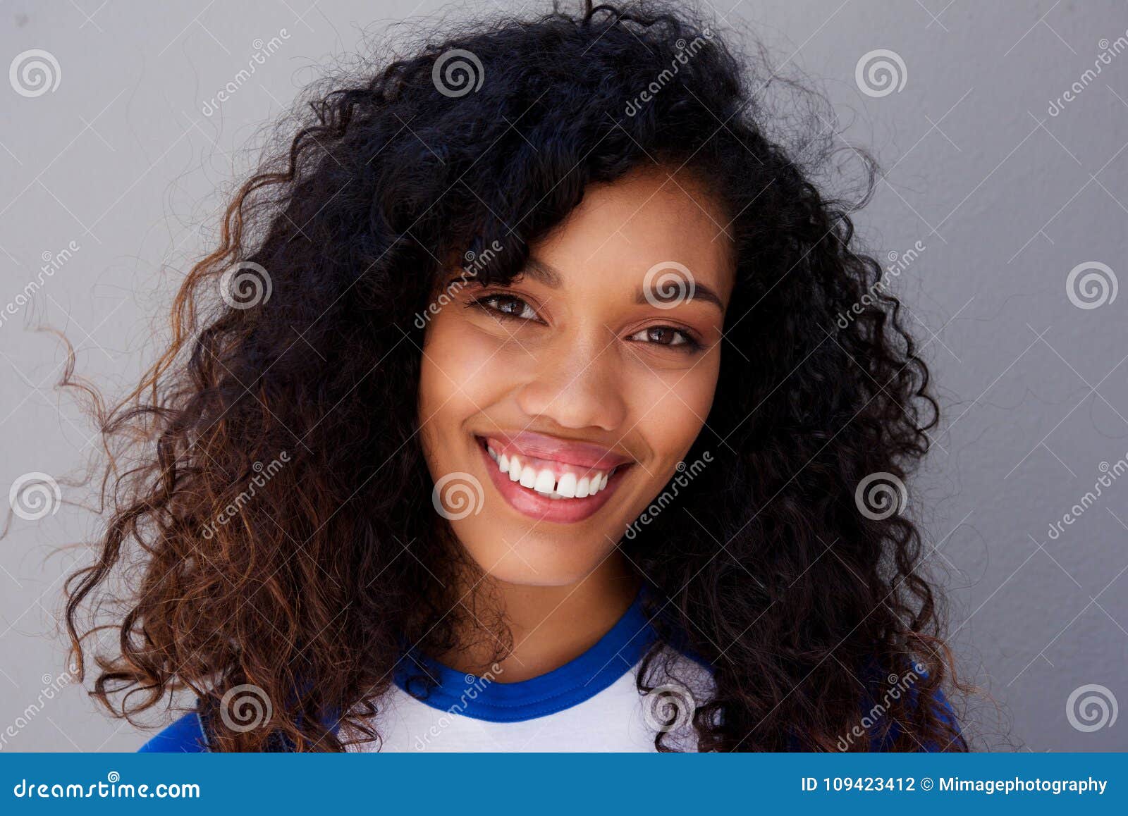 Horizontal Portrait of Smiling Young Black Woman Against Gray Wall ... Horizontal Portrait of Smiling Young Black Woman Against Gray Wall ...