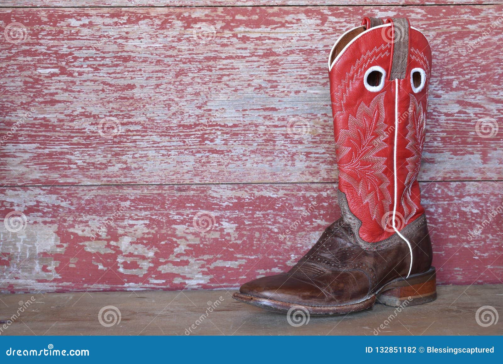 Red Cowboy Boots on Red Barn Board Stock Photo - Image of horizontal ...