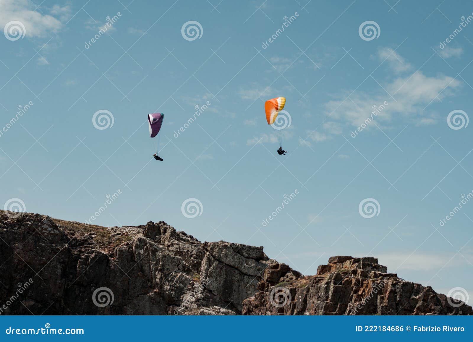 Horizontal Shot of Two Paragliders Gliding Over a Cliff Stock Photo ...