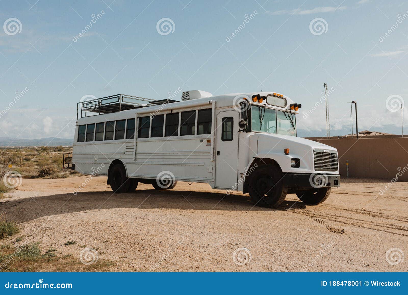 Horizontal Shot of a White Bus from the Side in a Dry Field during ...