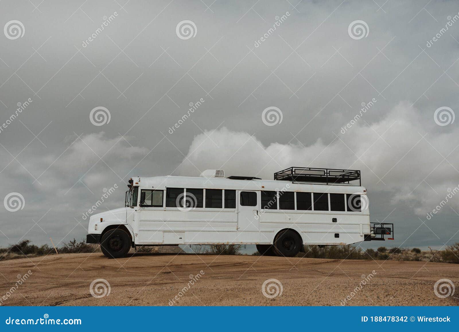 Horizontal Shot of a White Bus from the Side in a Dry Field during ...