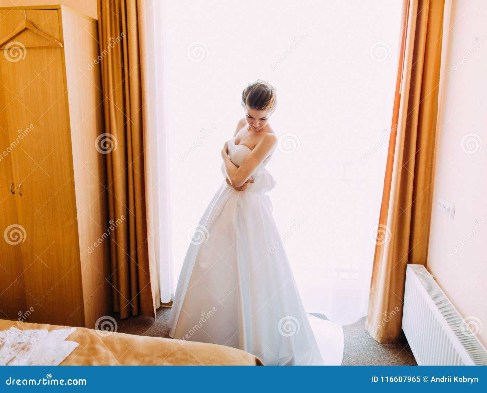 The Horizontal Side View of the Bride in the Long White Wedding Dress ...