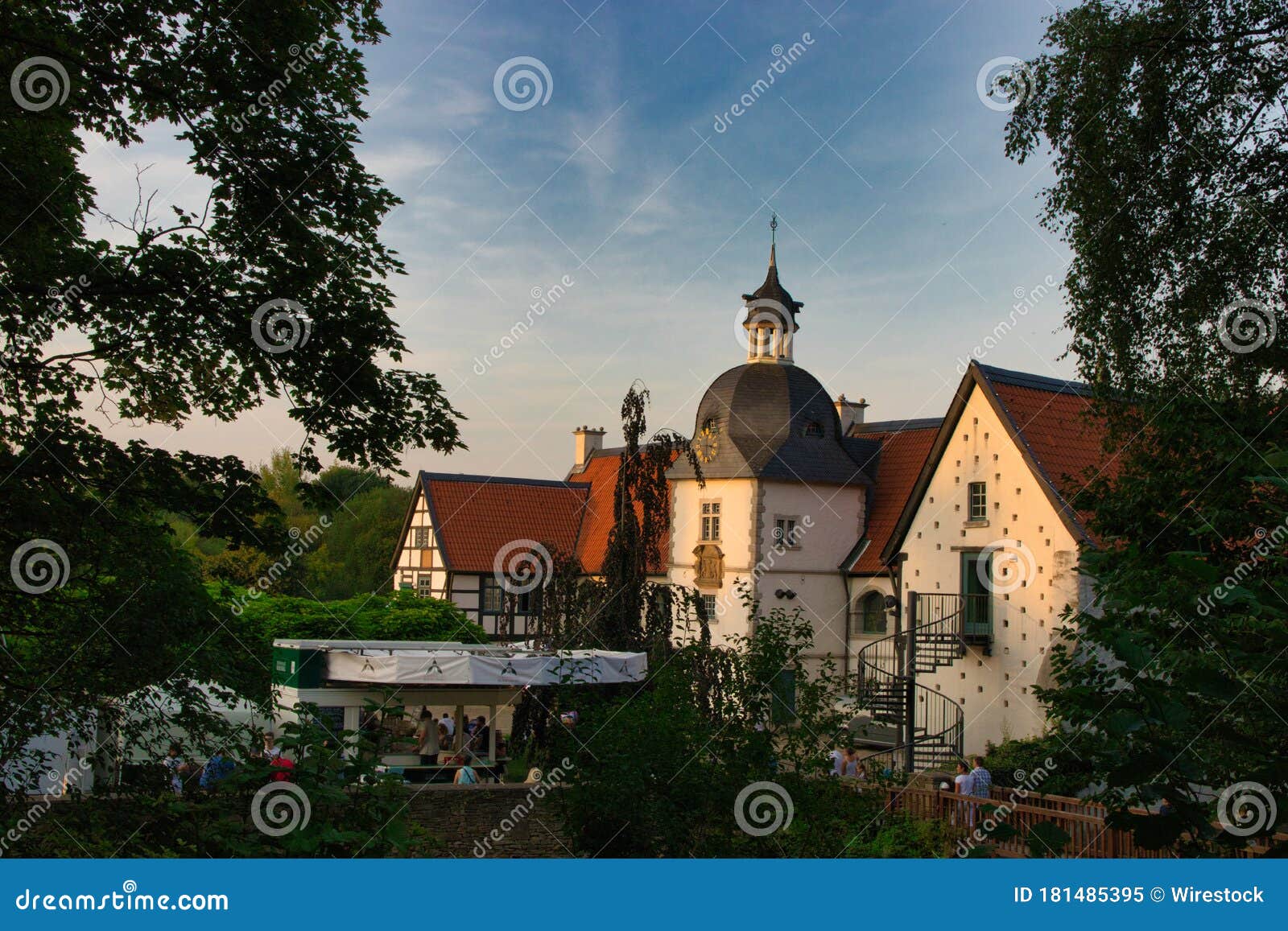 Horizontal View of a White Building with Brown Roof and a Garden in ...