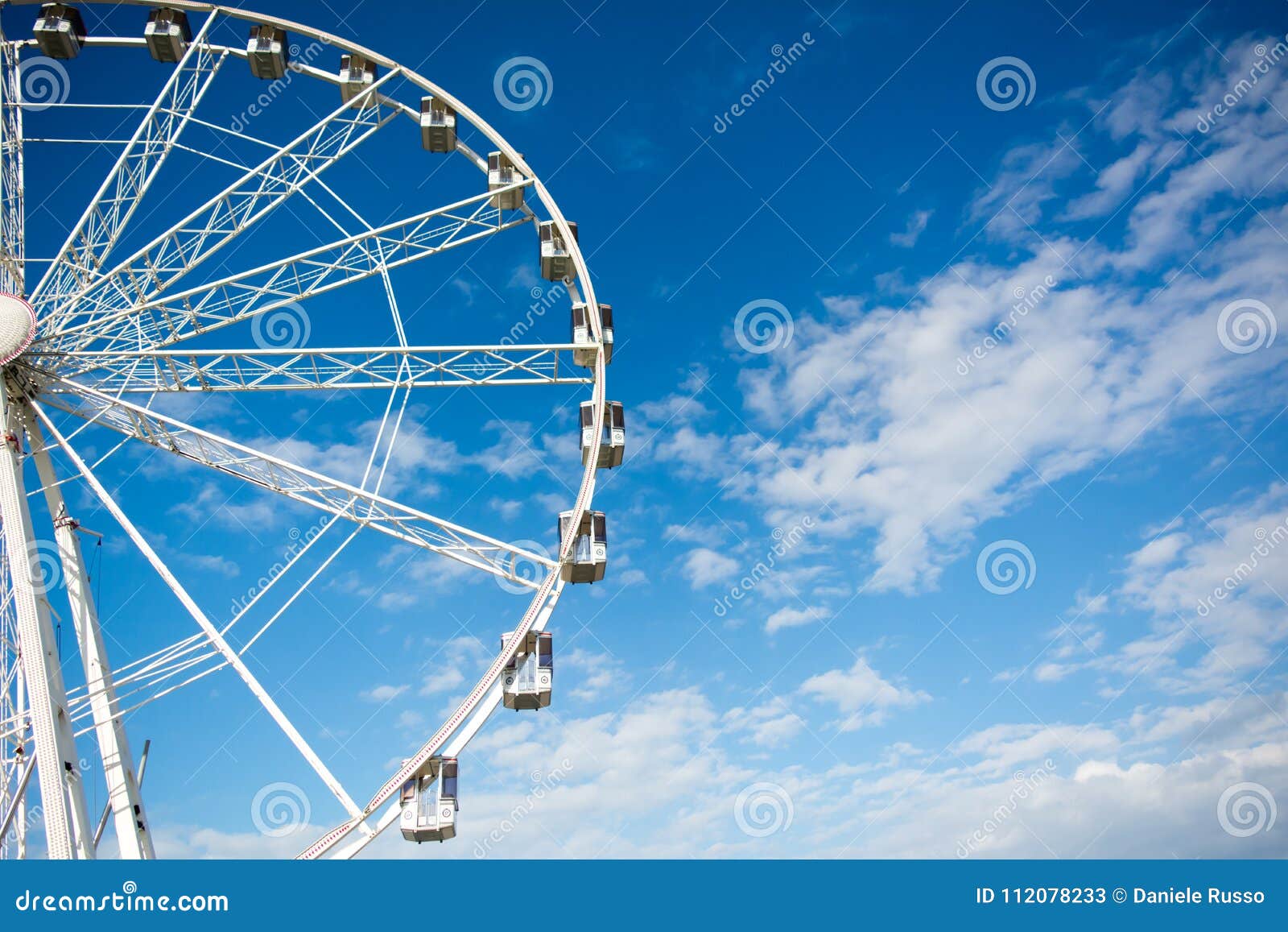 Horizontal View of a White Ferris Wheel on Partially Cloudy Sky Stock ...