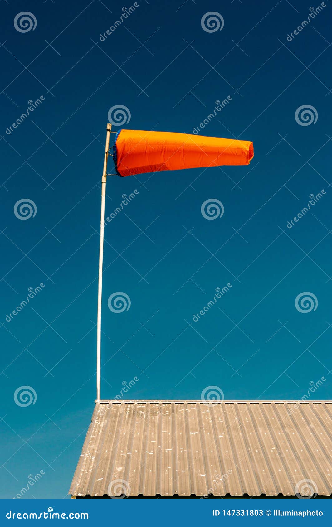 Horizontally Flying Orange Windsock on Metal Rooftop and Clear Dark ...