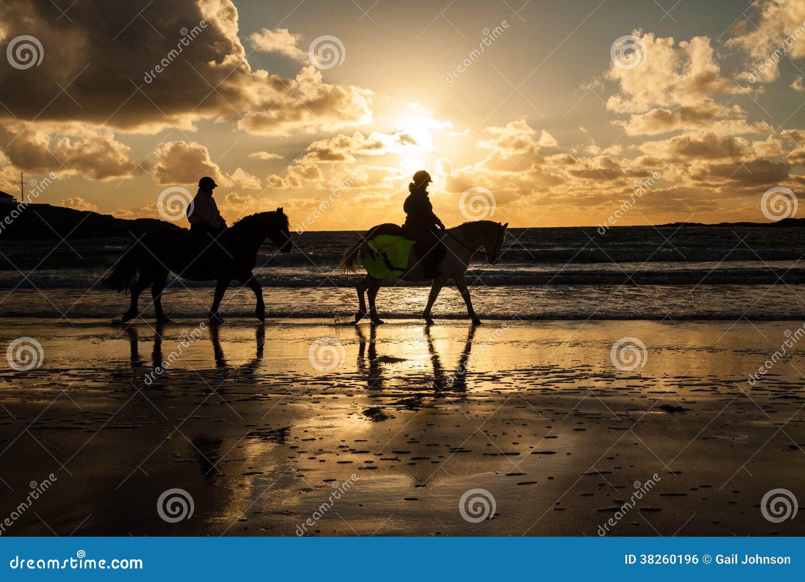 Horse riders at sunset stock photo. Image of beach, north - 38260196