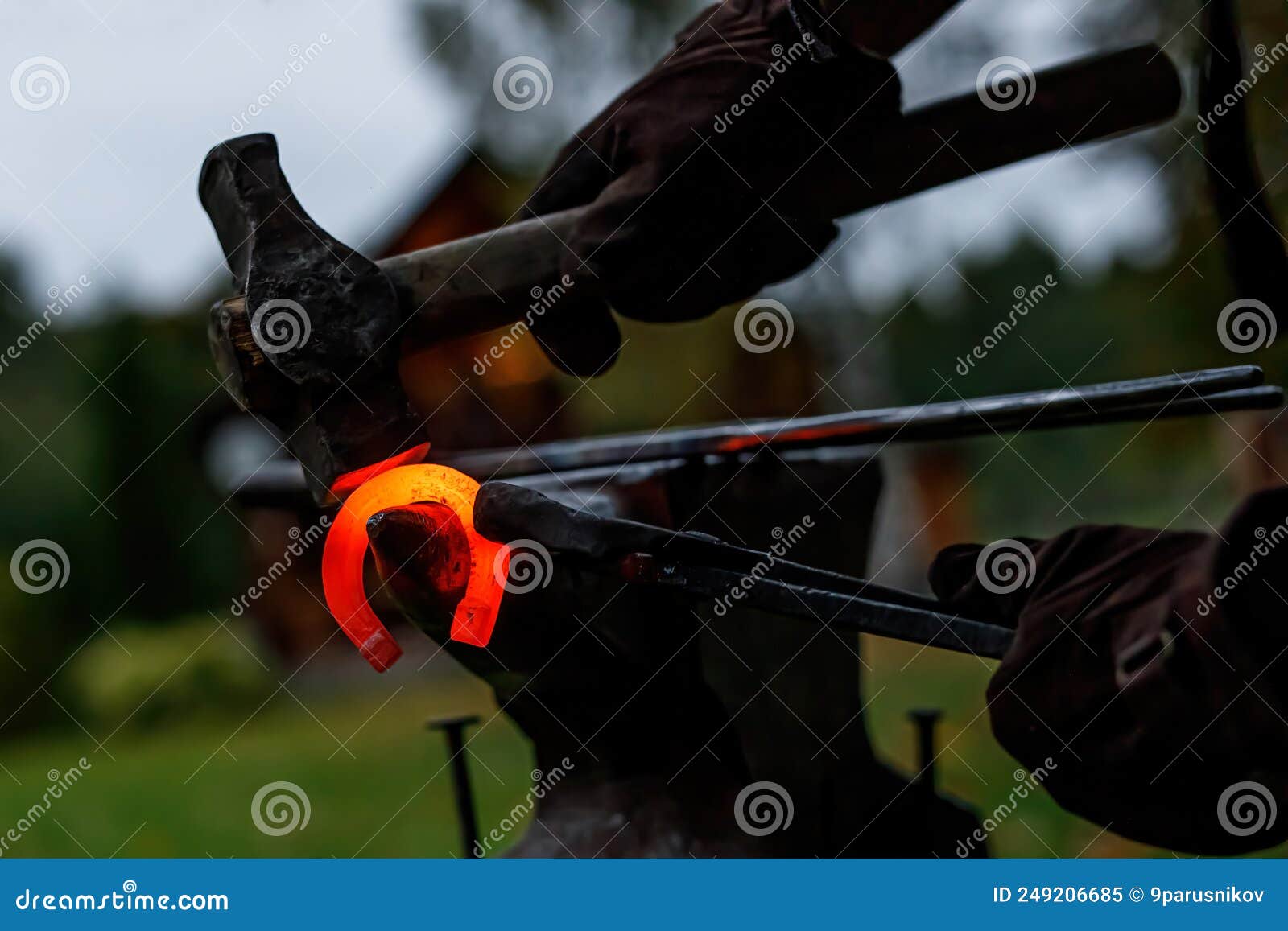 Horseshoe Production Process. a Blacksmith Bending Hot Metal on an ...