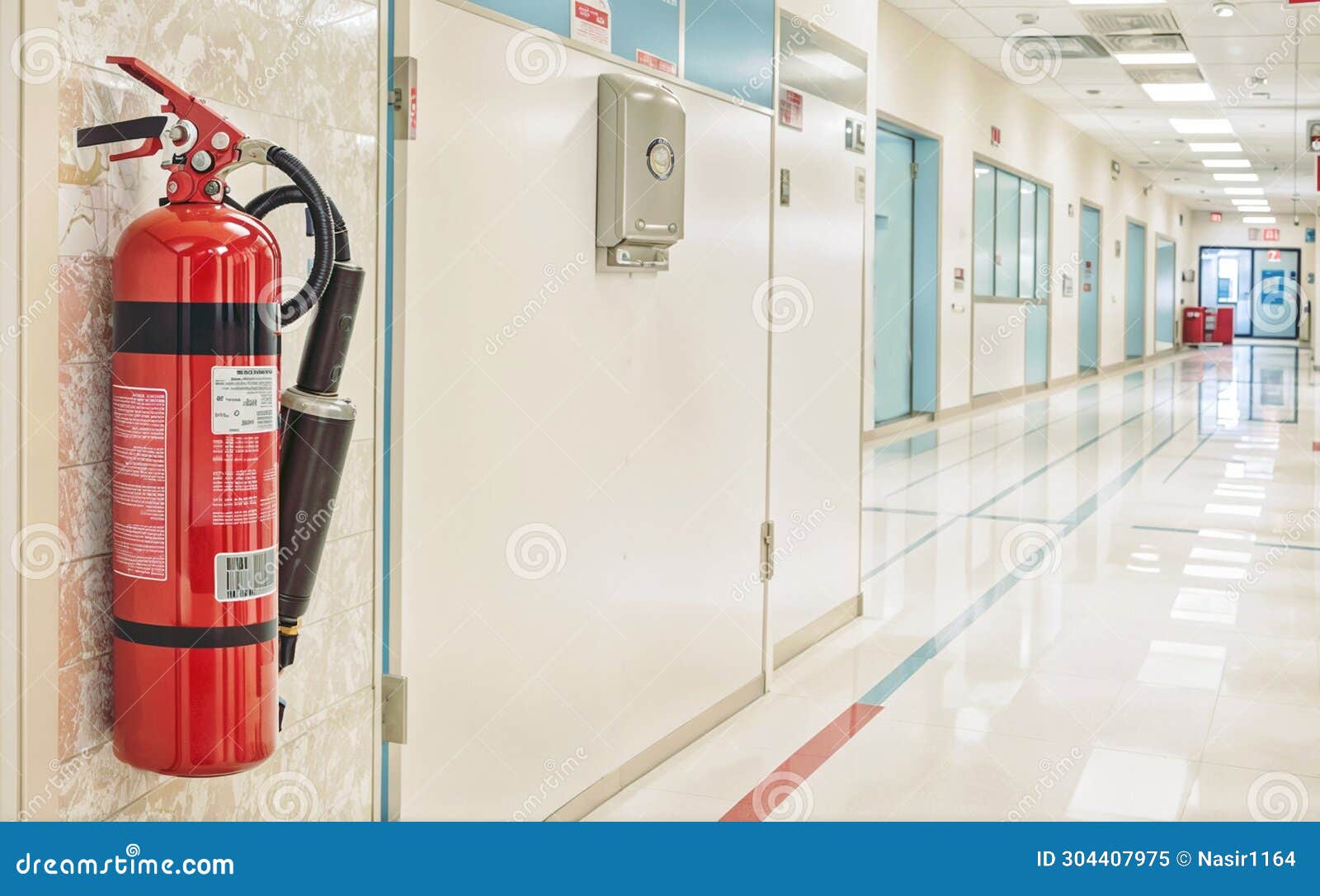 Within the Hospital Corridor, a Fire Extinguisher is Securely ...