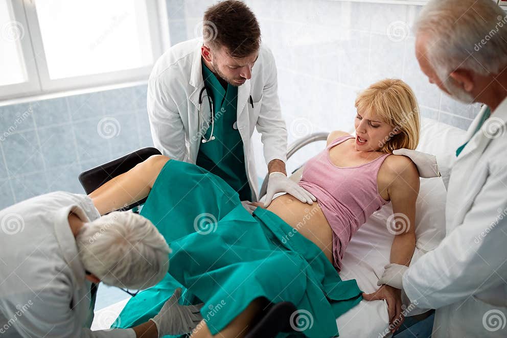 In The Hospital Woman In Labor Pushes To Give Birth Obstetricians