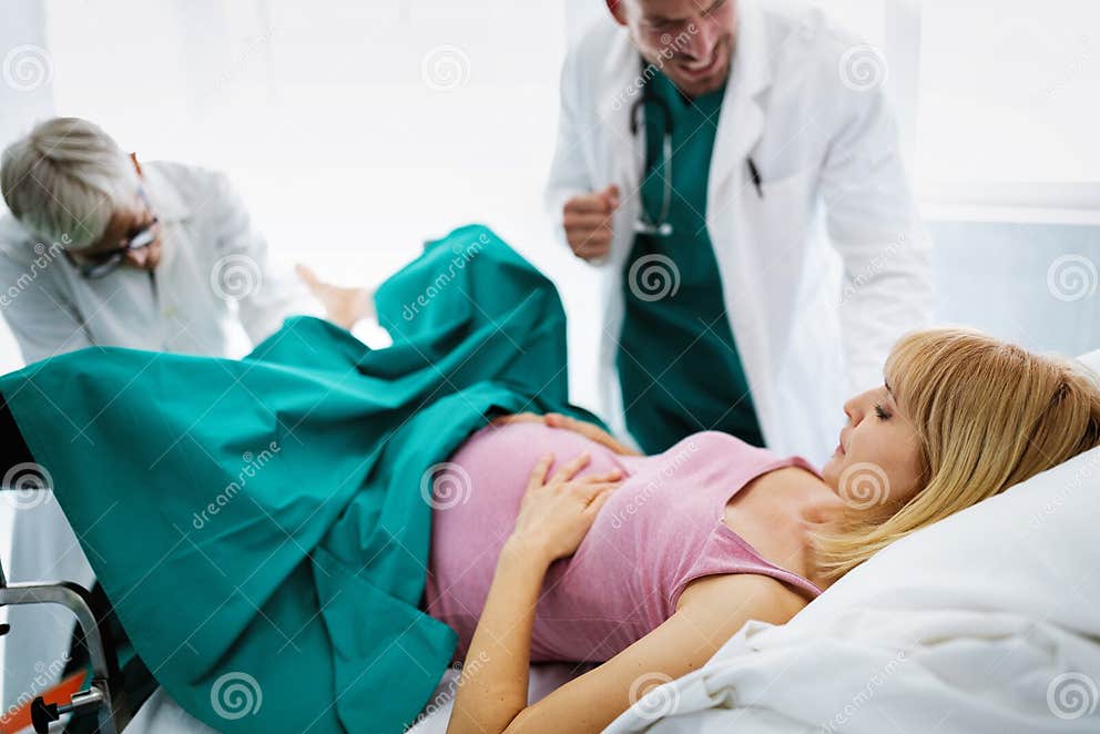 In The Hospital Woman In Labor Pushes To Give Birth Obstetricians