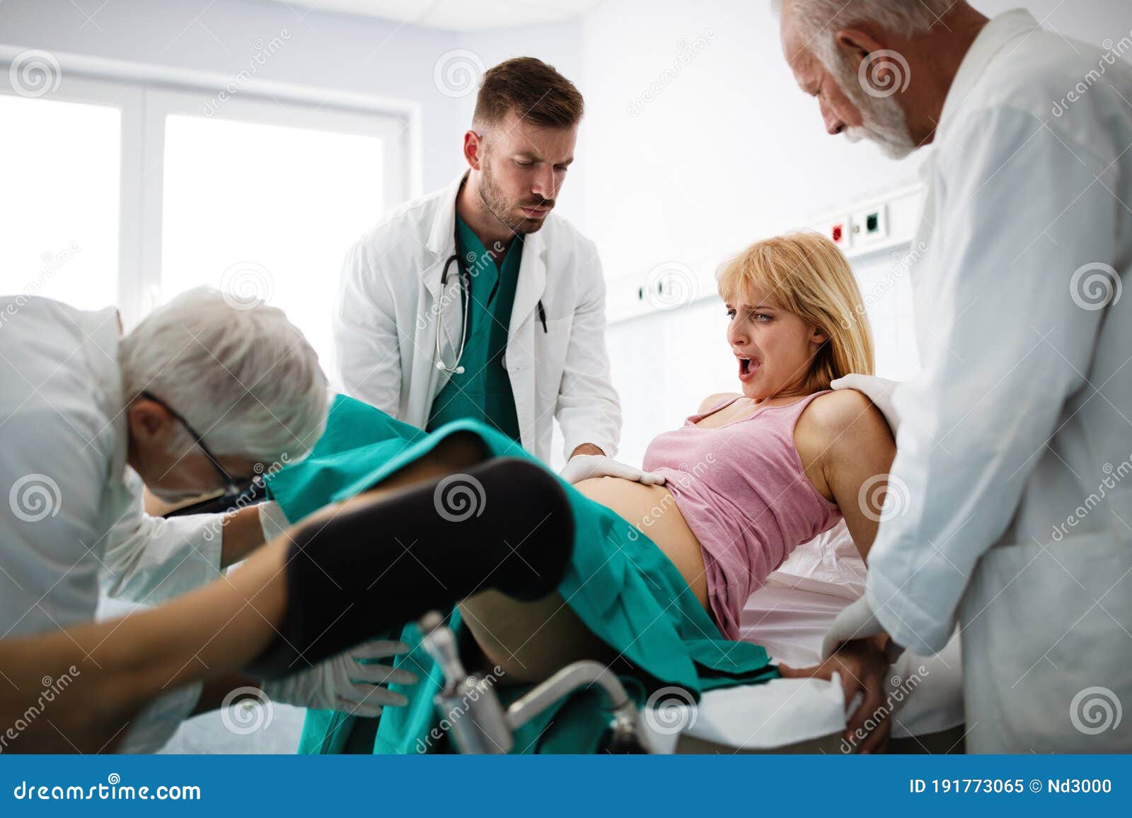 In The Hospital Woman In Labor Pushes To Give Birth Obstetricians