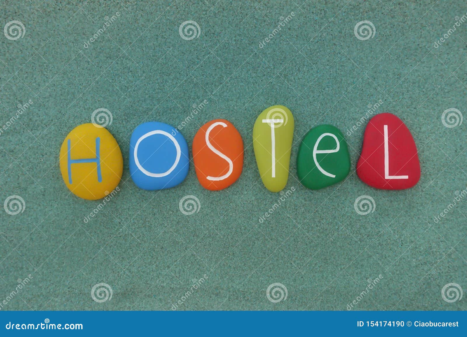 Hostel Text Composed with Colored Stones Over Green Sand Stock Photo ...