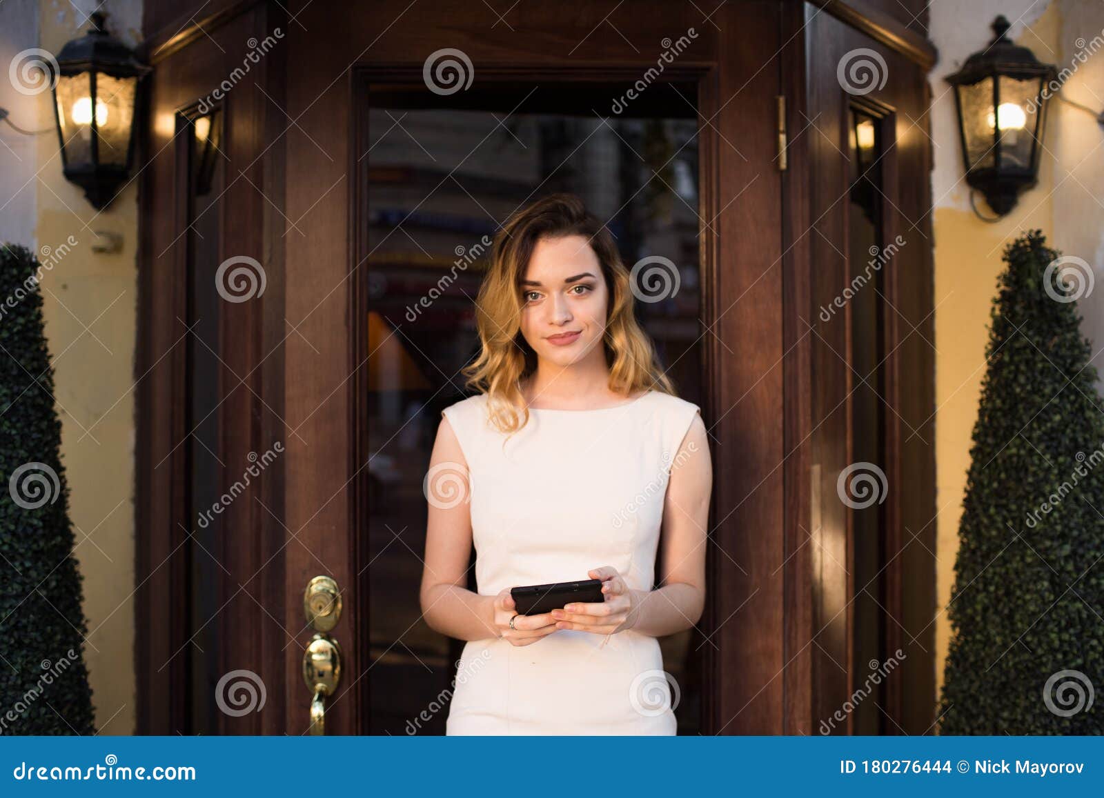 A Hostess Girl Stands with a Tablet and Greets Guests. Stock Photo ...