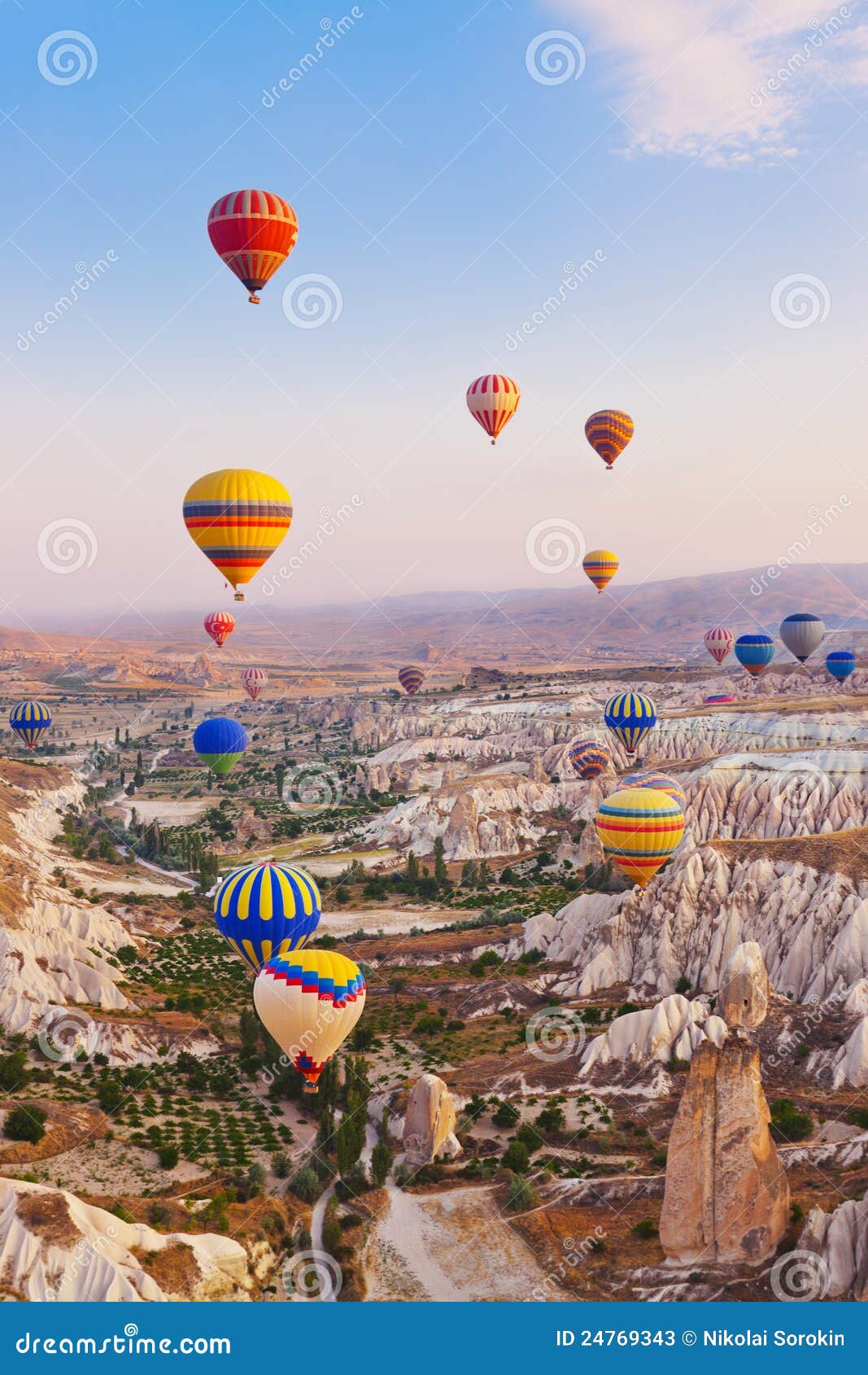 Hot Air Balloon Flying Over Rocky Landscape At Sunrise - Cappadocia ...