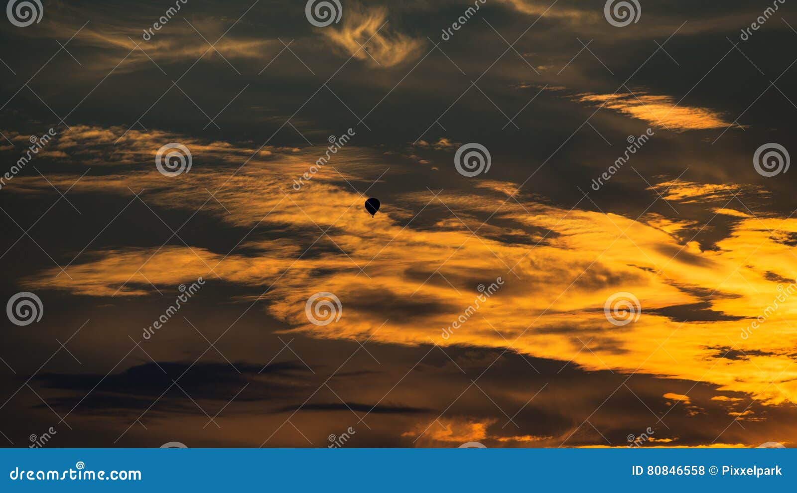Hot Air Balloon in the Sunset with Dramatic Clouds and Colors Stock ...
