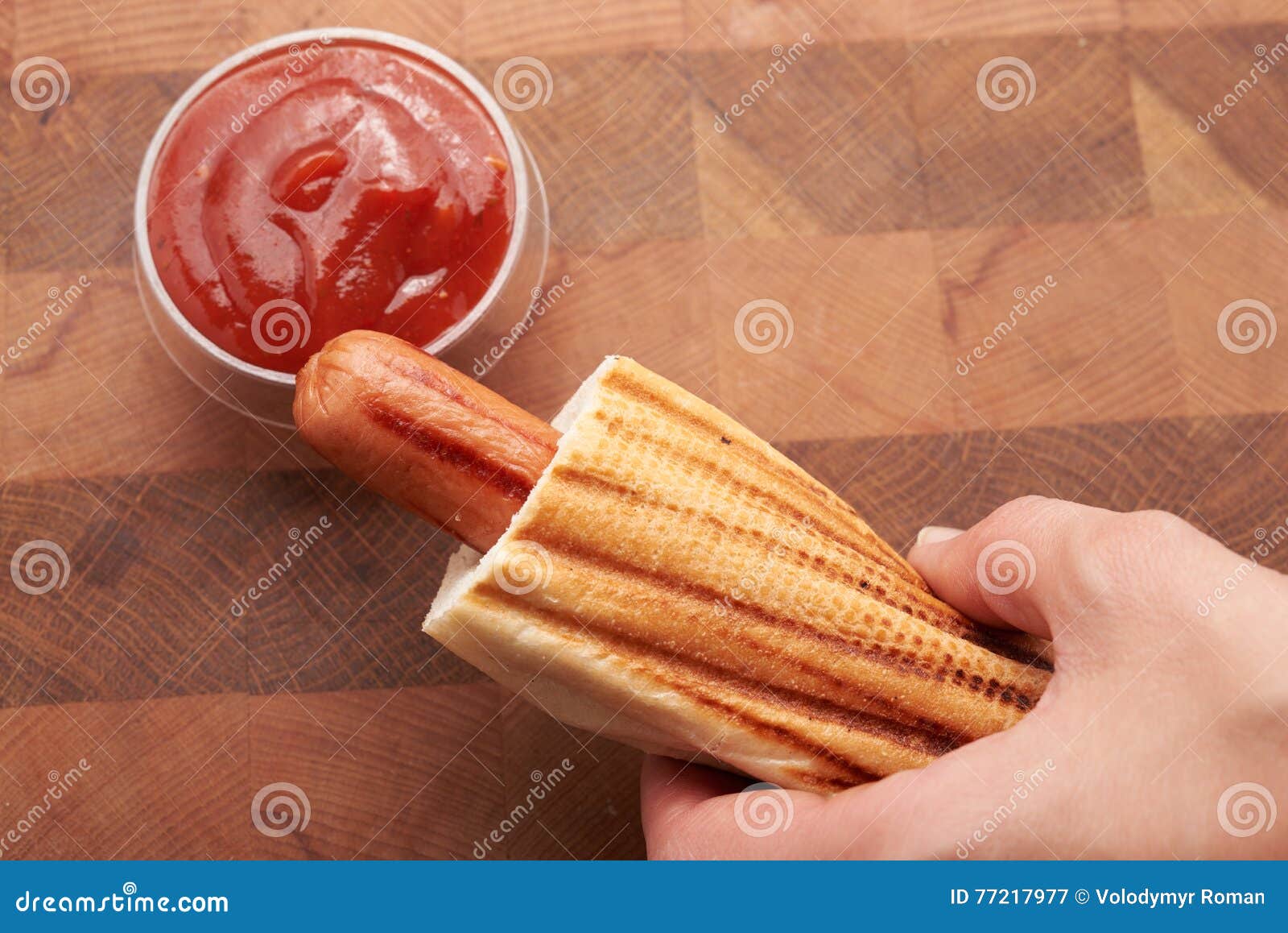 Hot Dog in Hand and Sauce on the Table Stock Image - Image of sandwich ...