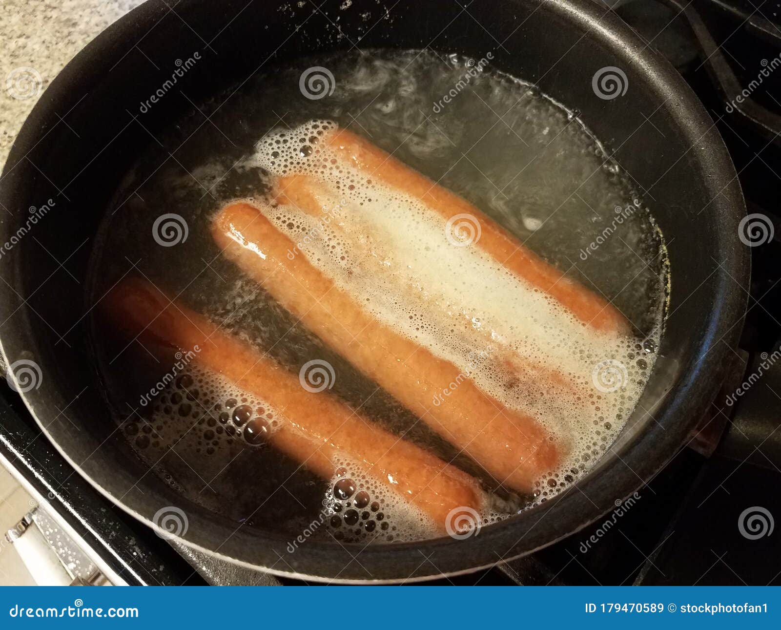 Hot Dogs Boiling in Water in Pan on Stove Stock Image - Image of snack ...