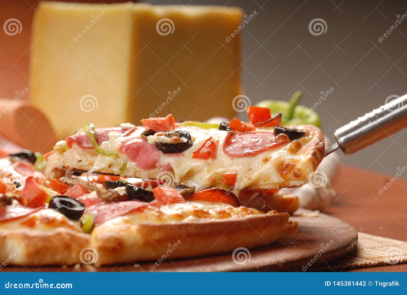 Hot Pizza Slice with Melting Cheese on a Rustic Wooden Table Stock ...