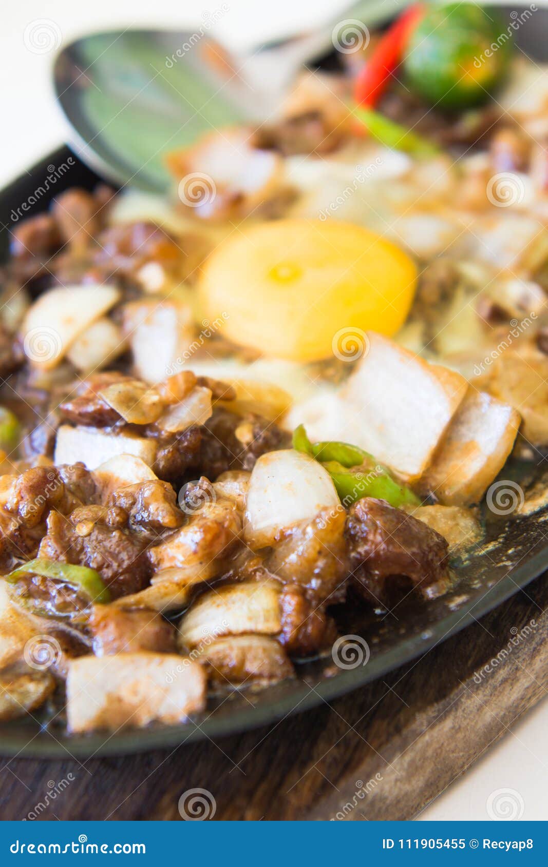 Spicy And Sizzling Pork Sisig Is A Favorite For Filipinos Close-up In A ...