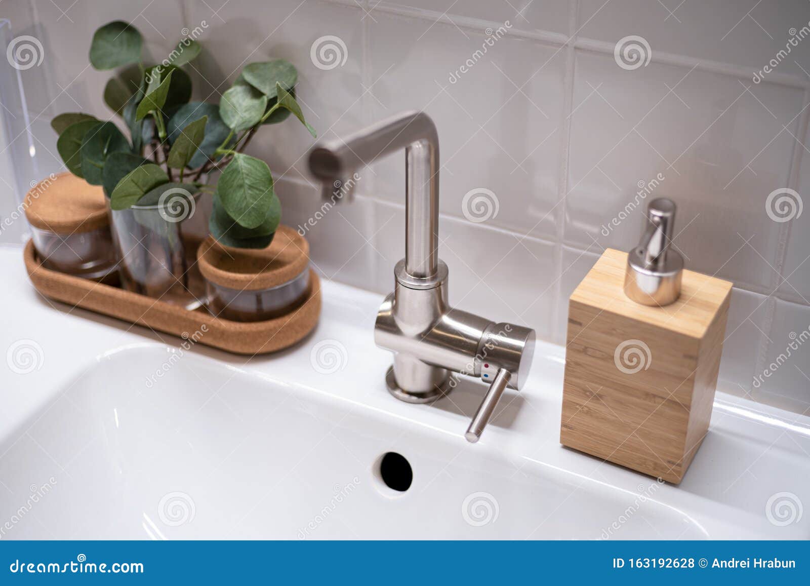 Hotel Bathroom with Sink, Tap, Flowers and Bathroom Set Stock Photo ...