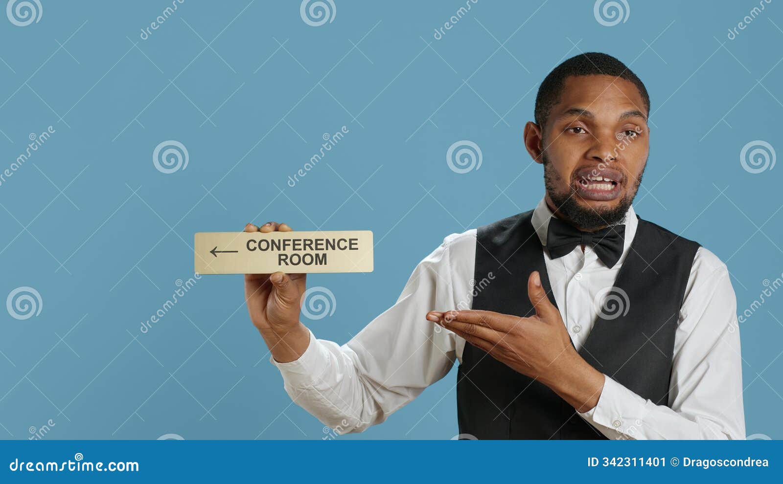 Hotel Concierge Using a Wall Indicator To Guide Clients To the ...