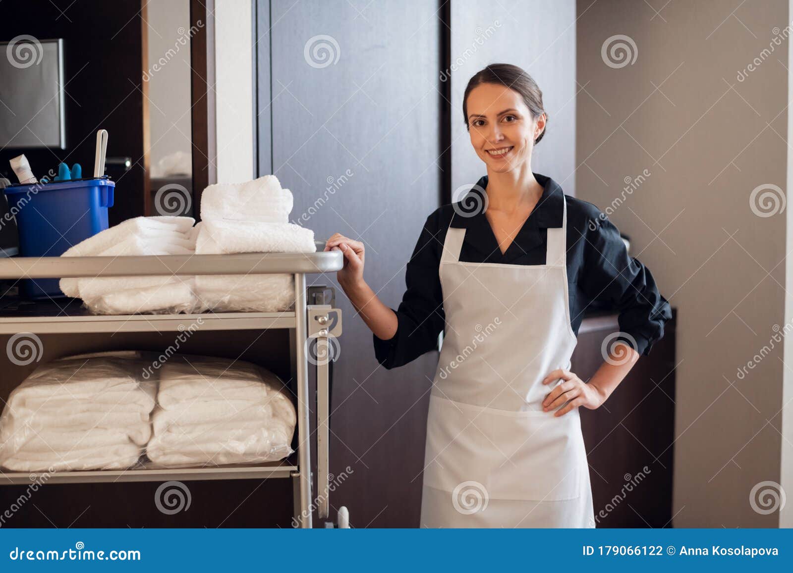 A Hotel Crew Member in a Uniform, Carrying Clean Towels Stock Photo ...