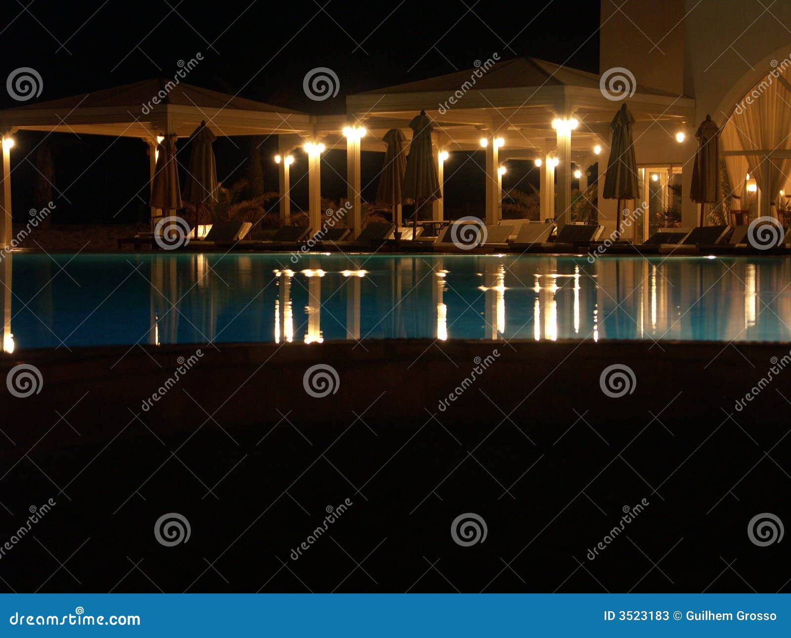 Hotel pool at night 1 stock image. Image of swimming, reflecting - 3523183