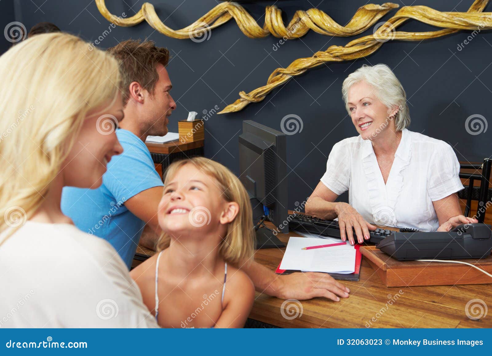 Hotel Receptionist Helping Family To Check in Stock Image - Image of ...