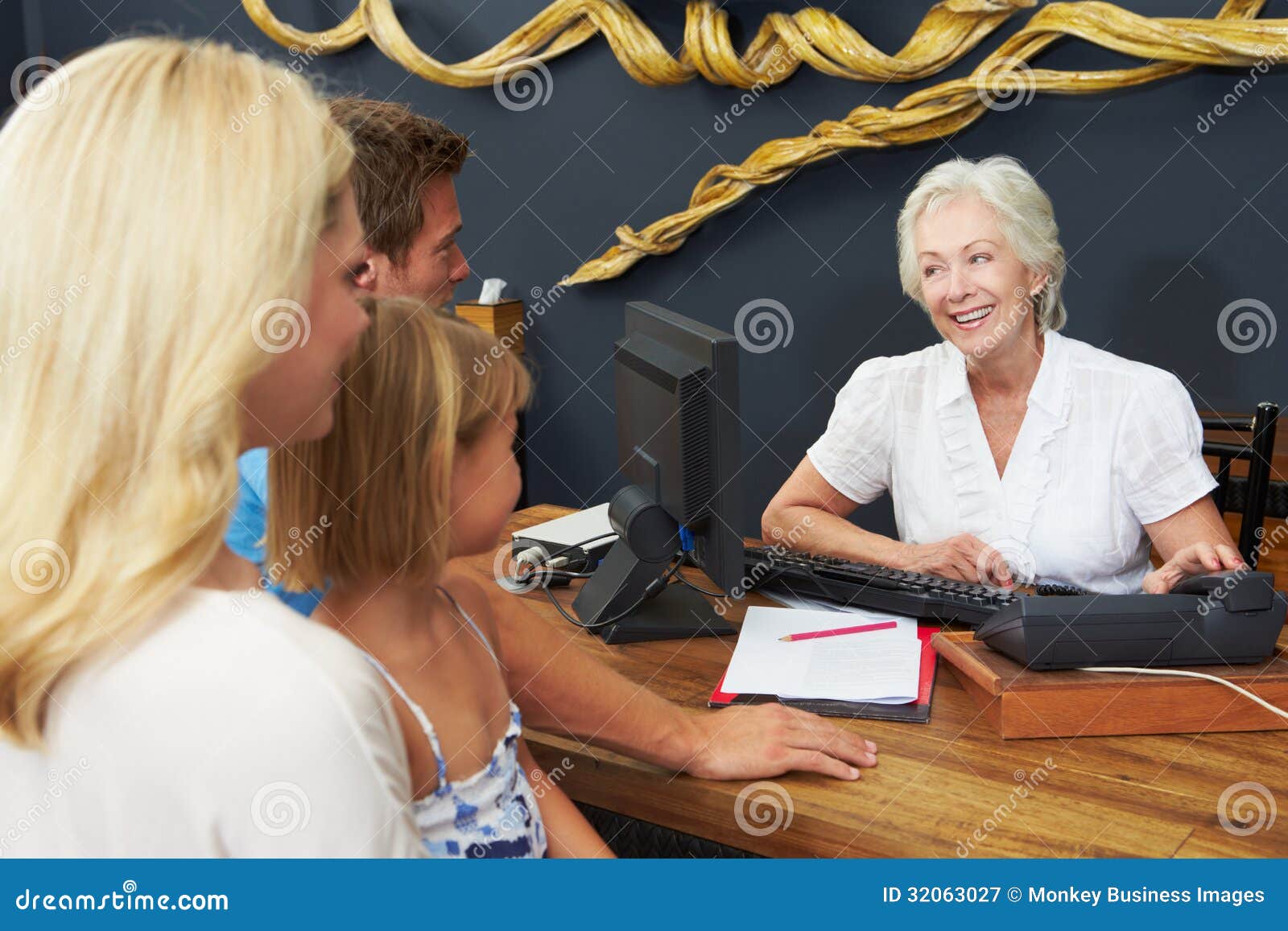 Hotel Receptionist Helping Family To Check in Stock Image - Image of ...