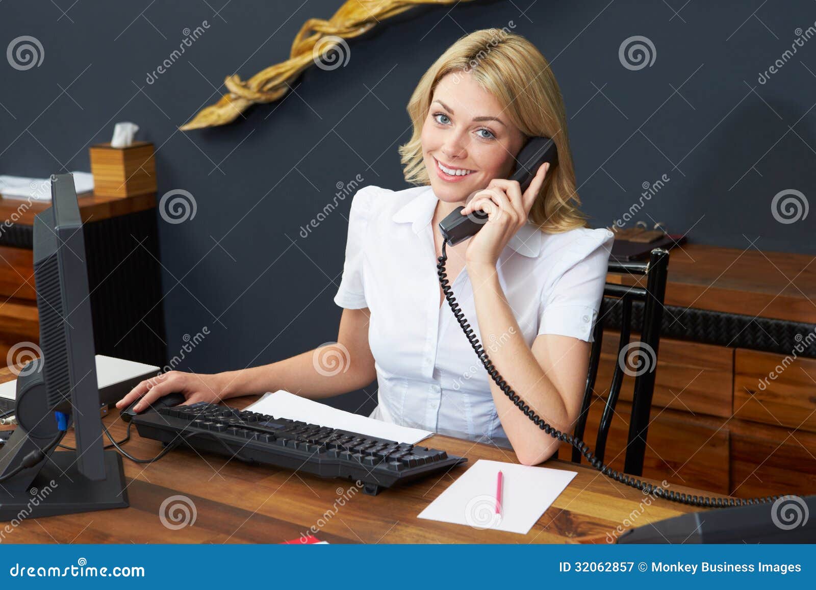 Hotel Receptionist Using Computer and Phone Stock Image - Image of ...