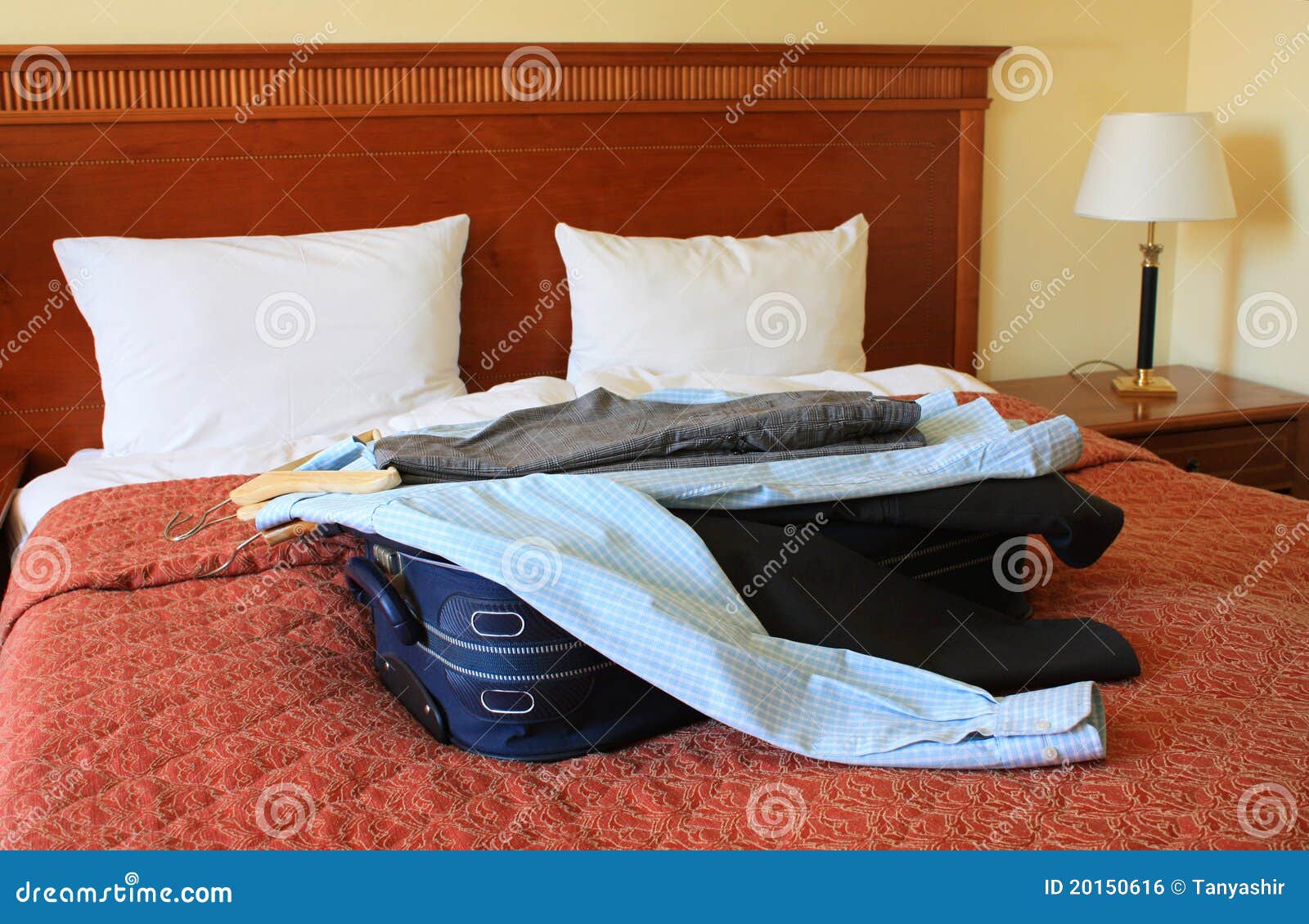 Hotel Room with Suitcase and Clothes Stock Photo - Image of bedspread ...