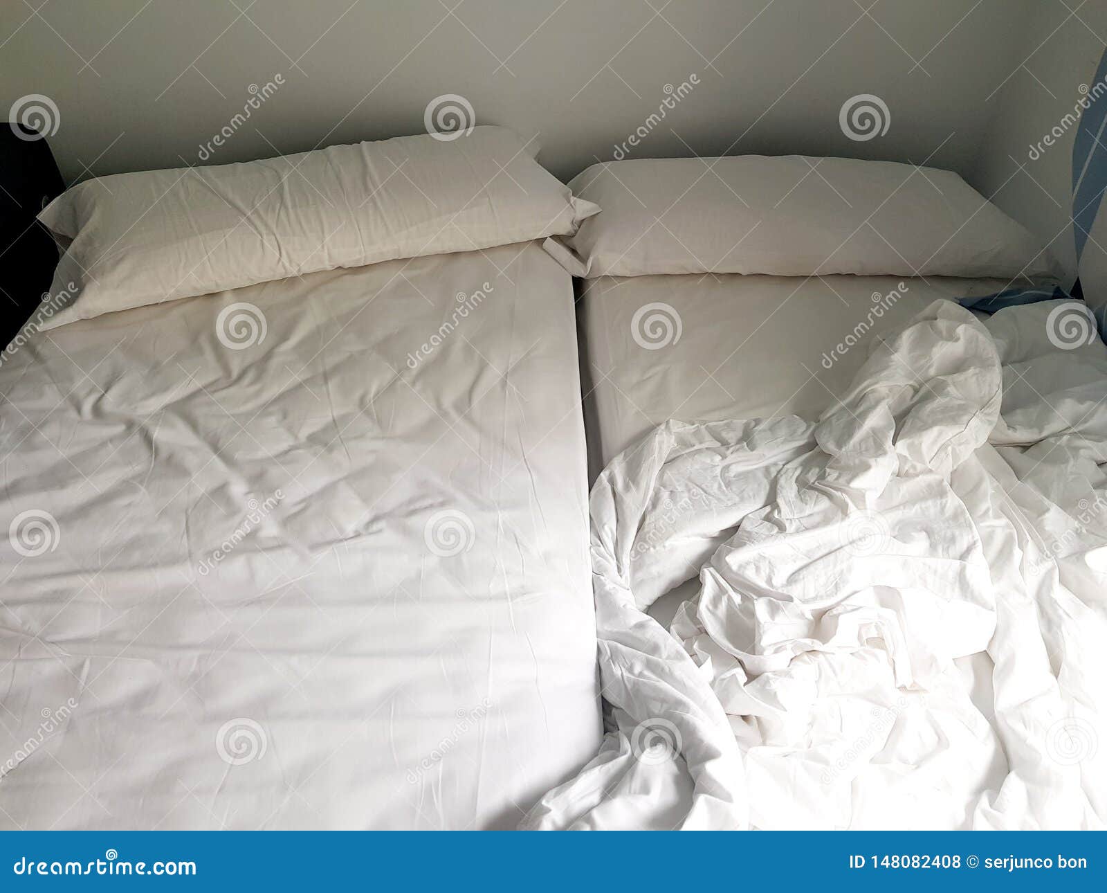 In a Hotel Room Two Beds Placed Together but with the Sheets Untidy ...