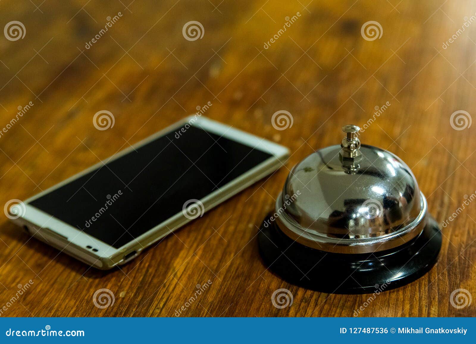 Hotel Service Call Bell and Smartphone on Wooden Reception Front Stock ...