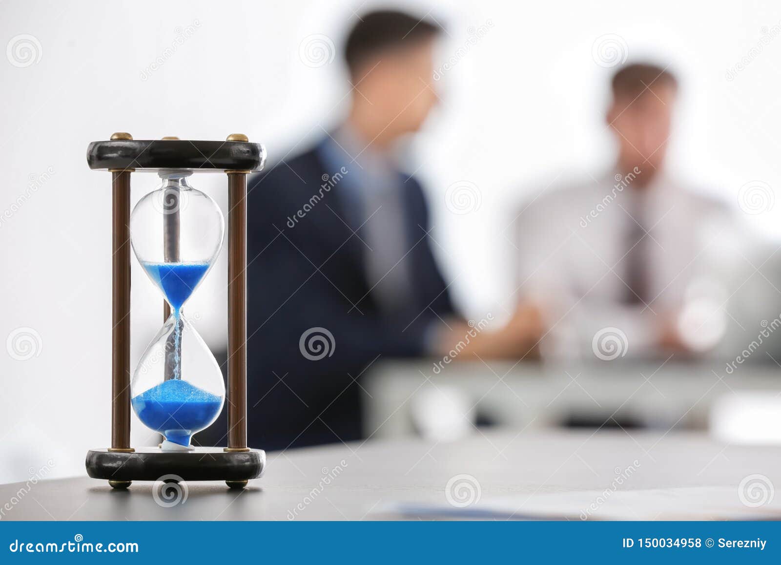 Hourglass and Blurred People on Background. Time Management Concept ...