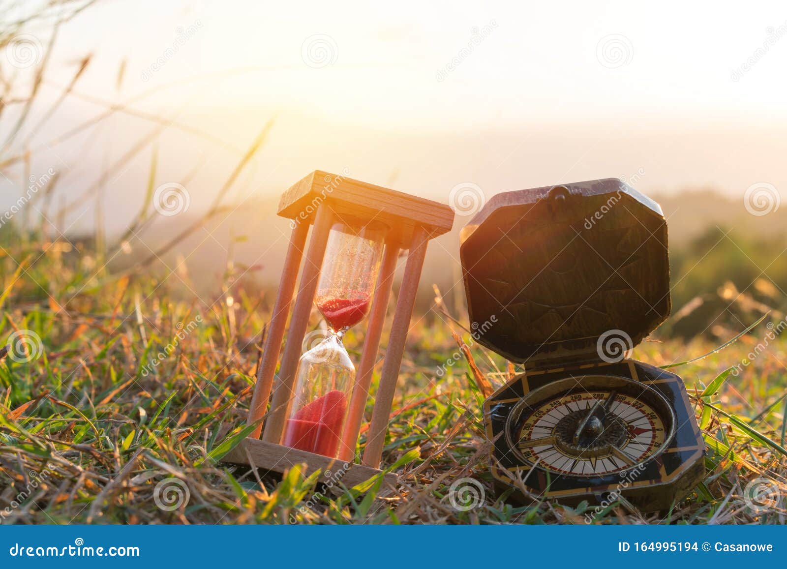 Hourglass and Compass with Sunrise in the Morning at Mountain Stock ...