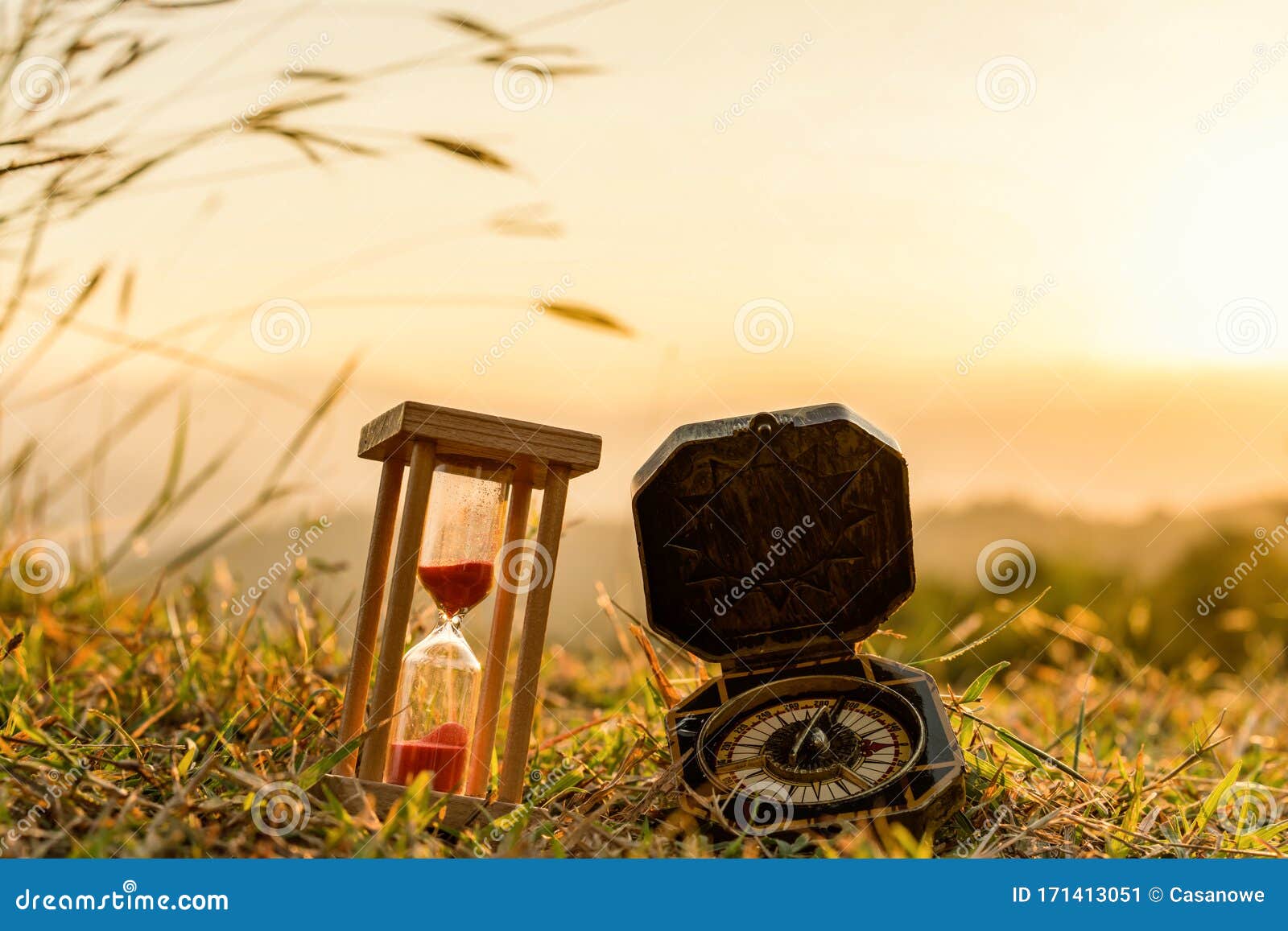Hourglass and Compass with Sunrise in the Morning at Mountain Stock ...